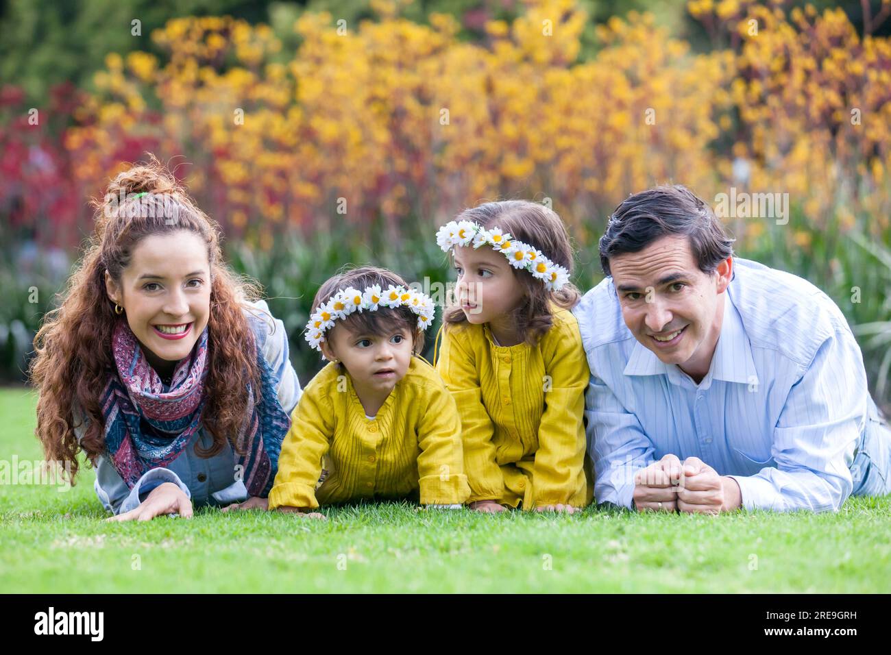 Family of four having fun outdoors in a beautiful sunny day at the park ...