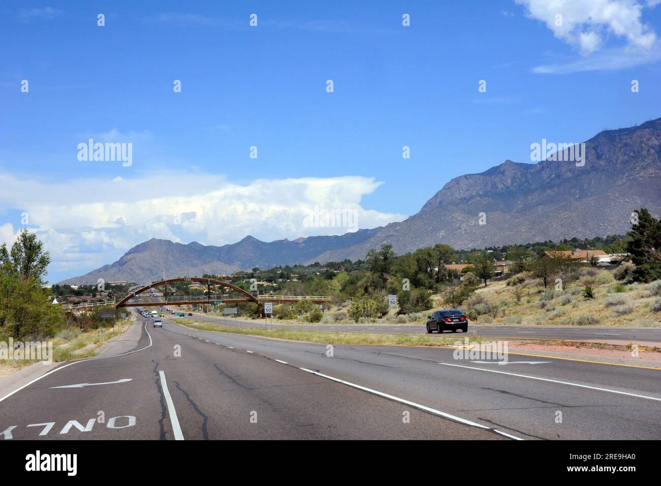 Four lane street tavels at the foot of the Sandia Mountains in ...