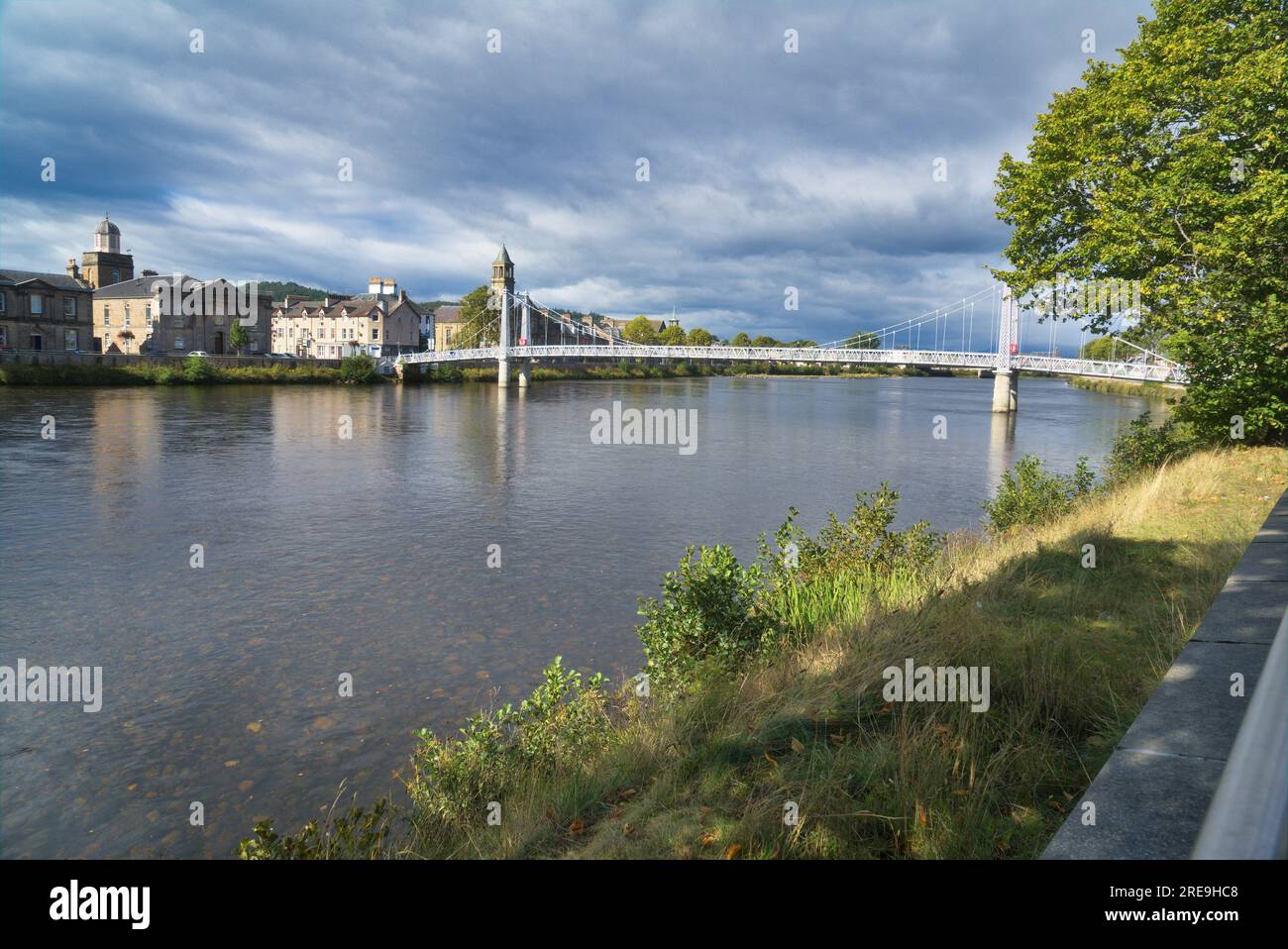 Looking north up tree lined footpath beside River ness near the centre ...