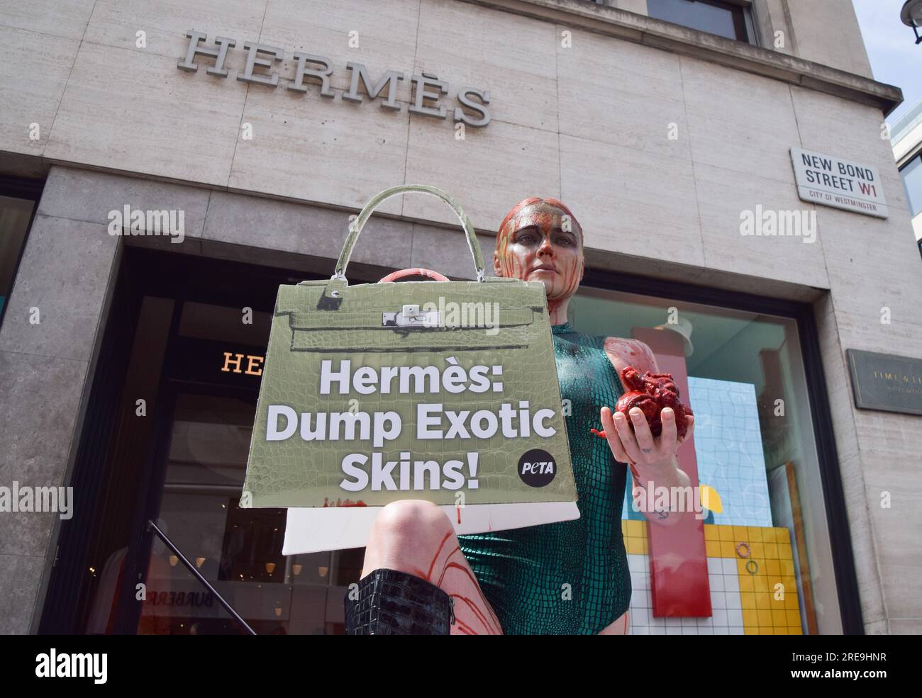London, UK. 26th July, 2023. Vegan activist Tash Peterson, covered in ...