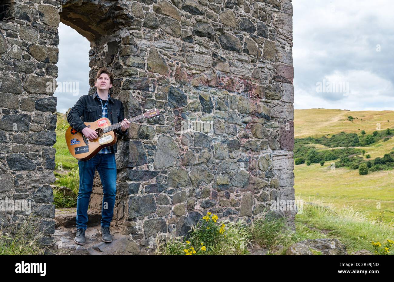 The Lonely Together musician Mike Baillie playing guitar at ruins of St ...