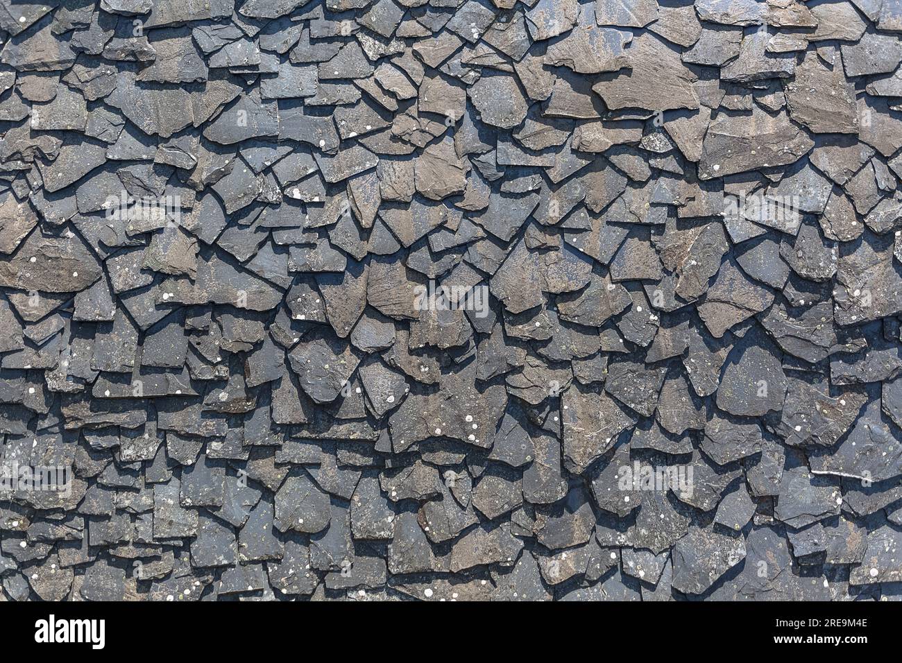 Detailed view of wall texture randomly lined with slate panels, typical ...