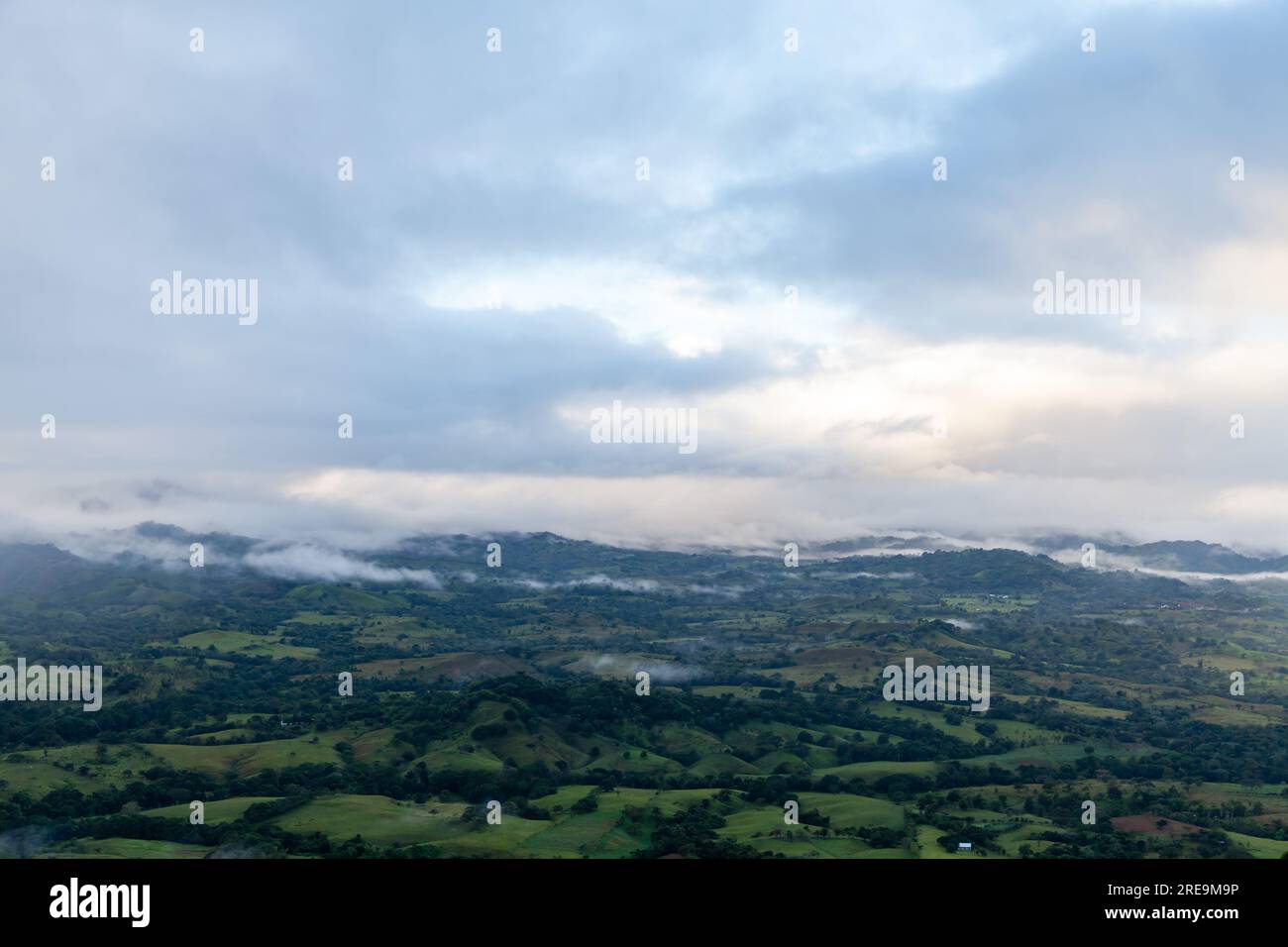 Natural landscape with a valley under cloudy sky on a rainy morning ...