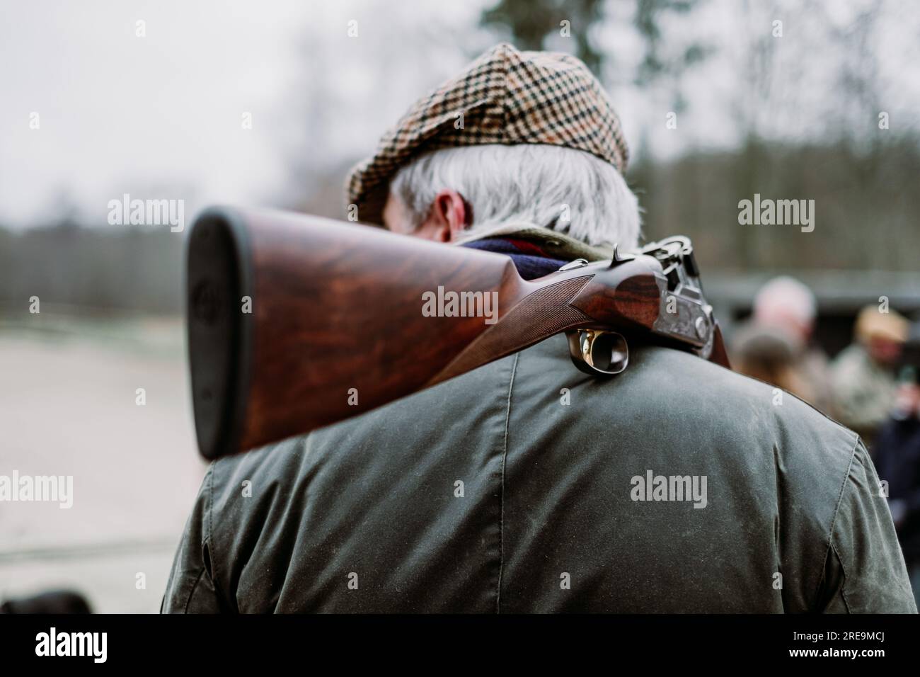 Older man on a hunt. Senior hunter with grey hair, tweed cap and ...