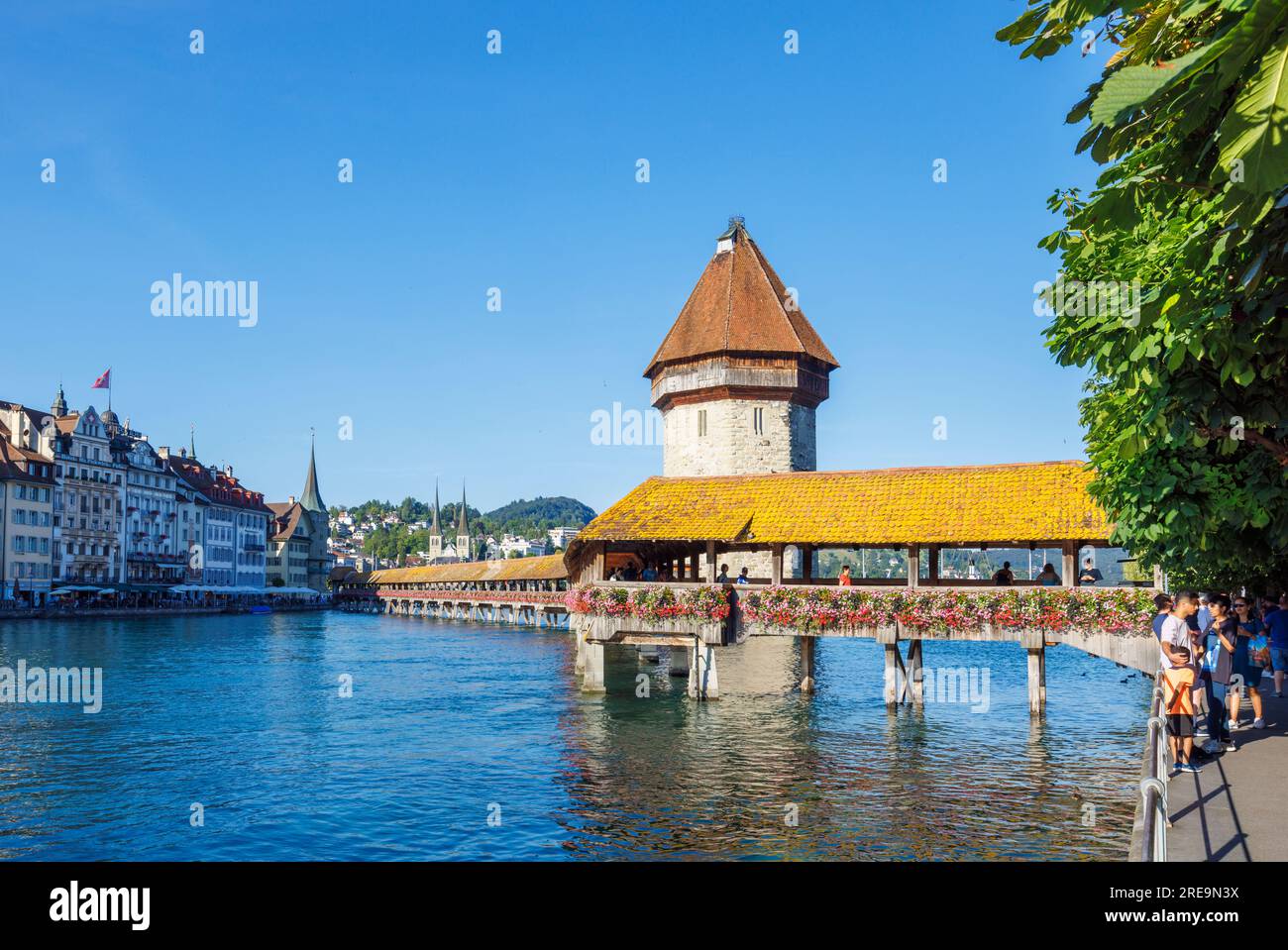 The historic wooden Chapel Bridge (Kapellbrucke) spanning the River ...
