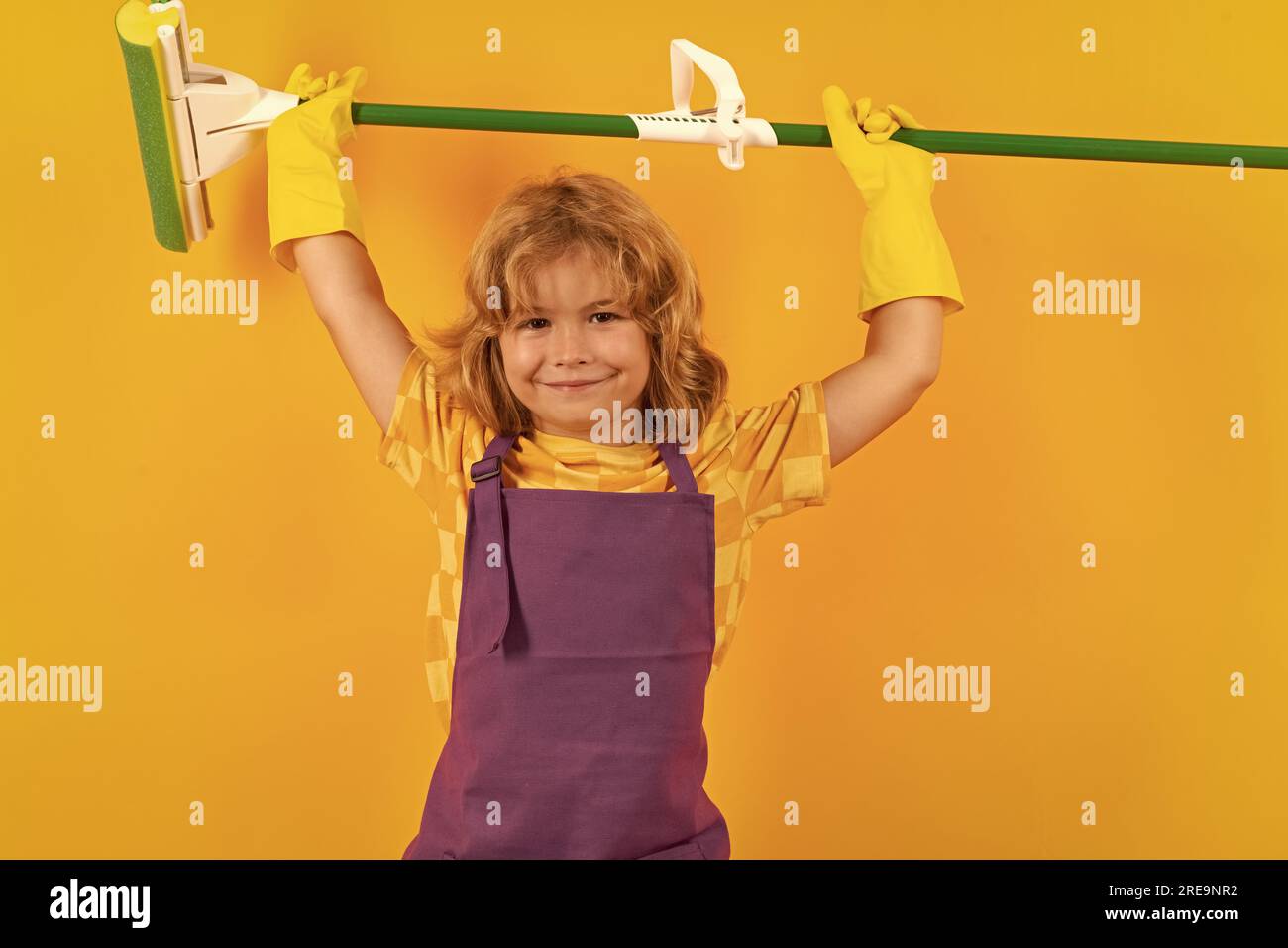 Cleaning house. Studio isolated portrait of child mopping house ...