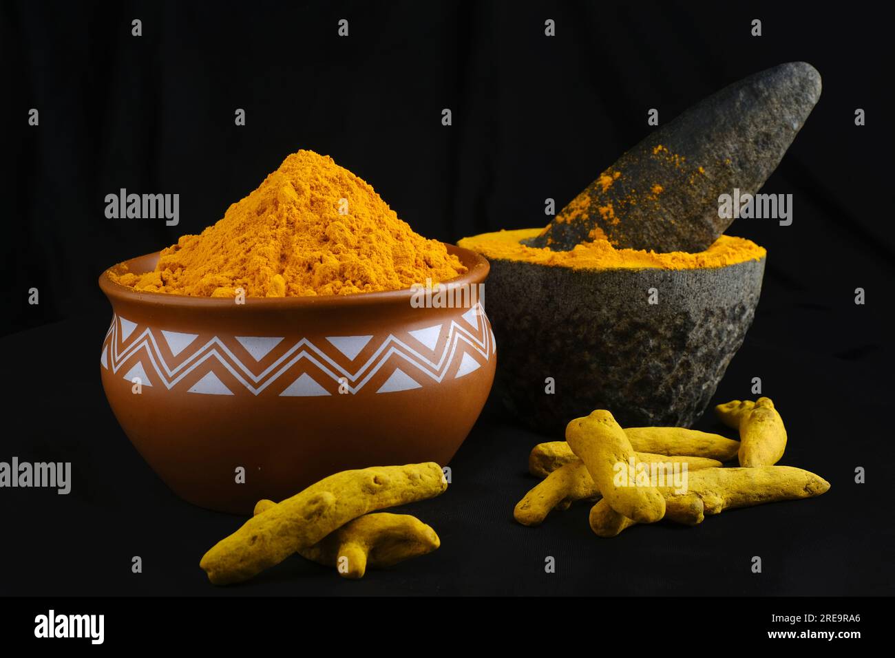 Dry turmeric powder (curcuma longa linn) stone mortar, traditional ...