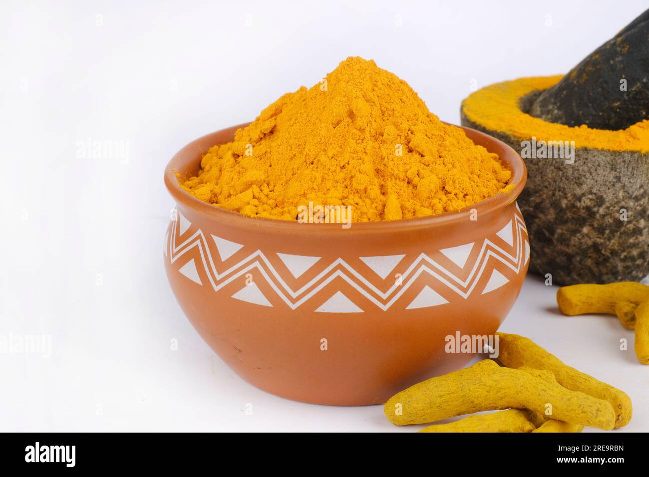 Dry turmeric powder (curcuma longa linn) stone mortar, traditional ...