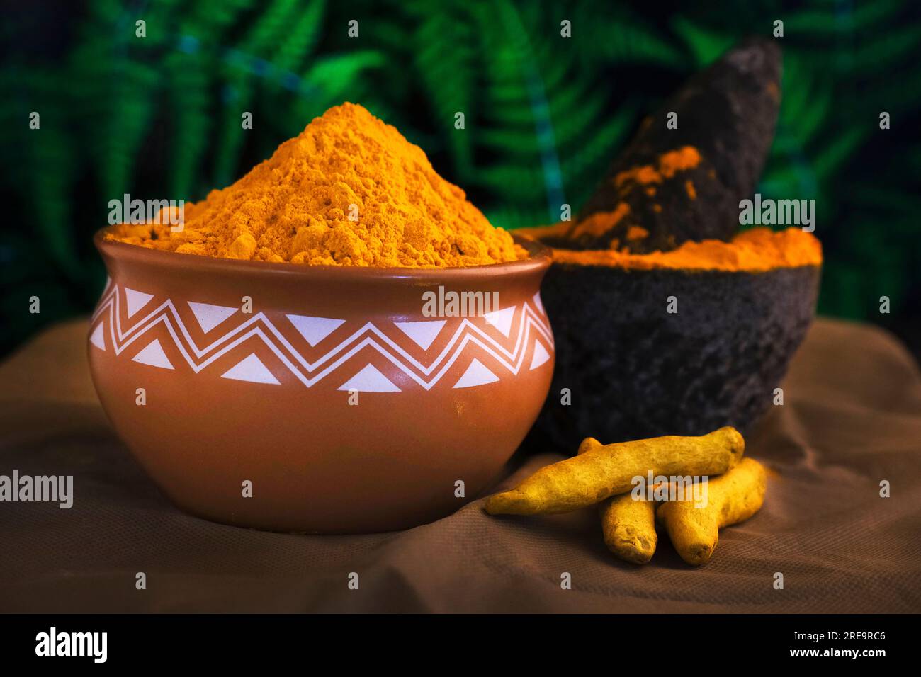 Dry turmeric powder (curcuma longa linn) stone mortar, traditional ...
