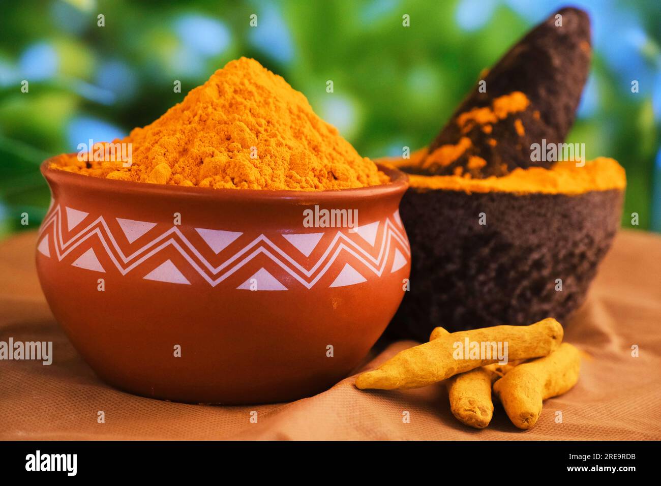 Dry turmeric powder (curcuma longa linn) stone mortar, traditional ...