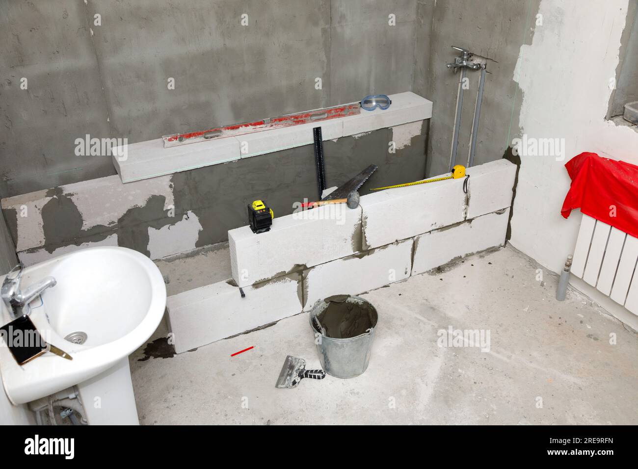 Interior of a new bathroom with the concrete blocks and construction ...