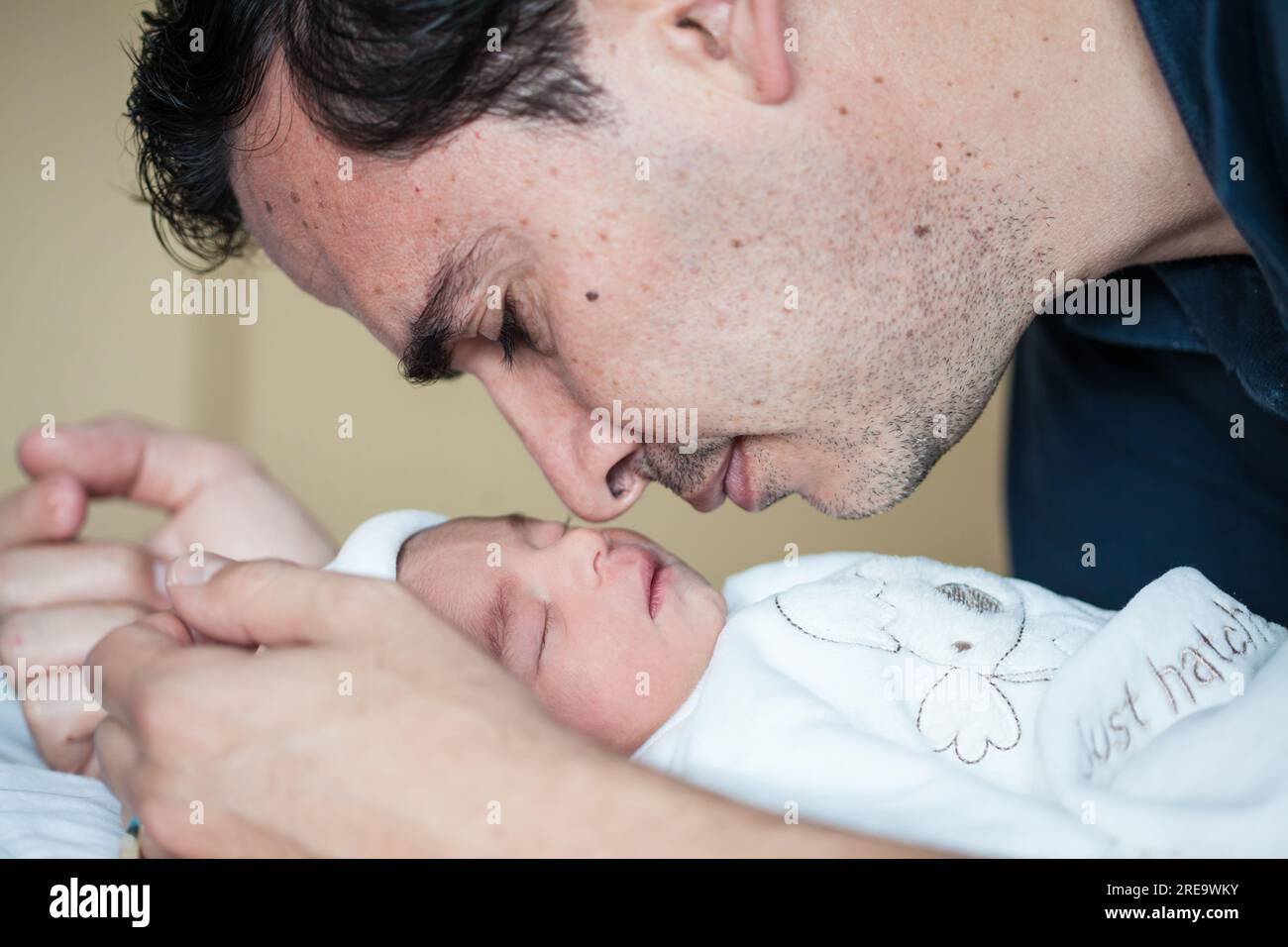 Newborn girl with her dad in the hospital on the day of her birth ...