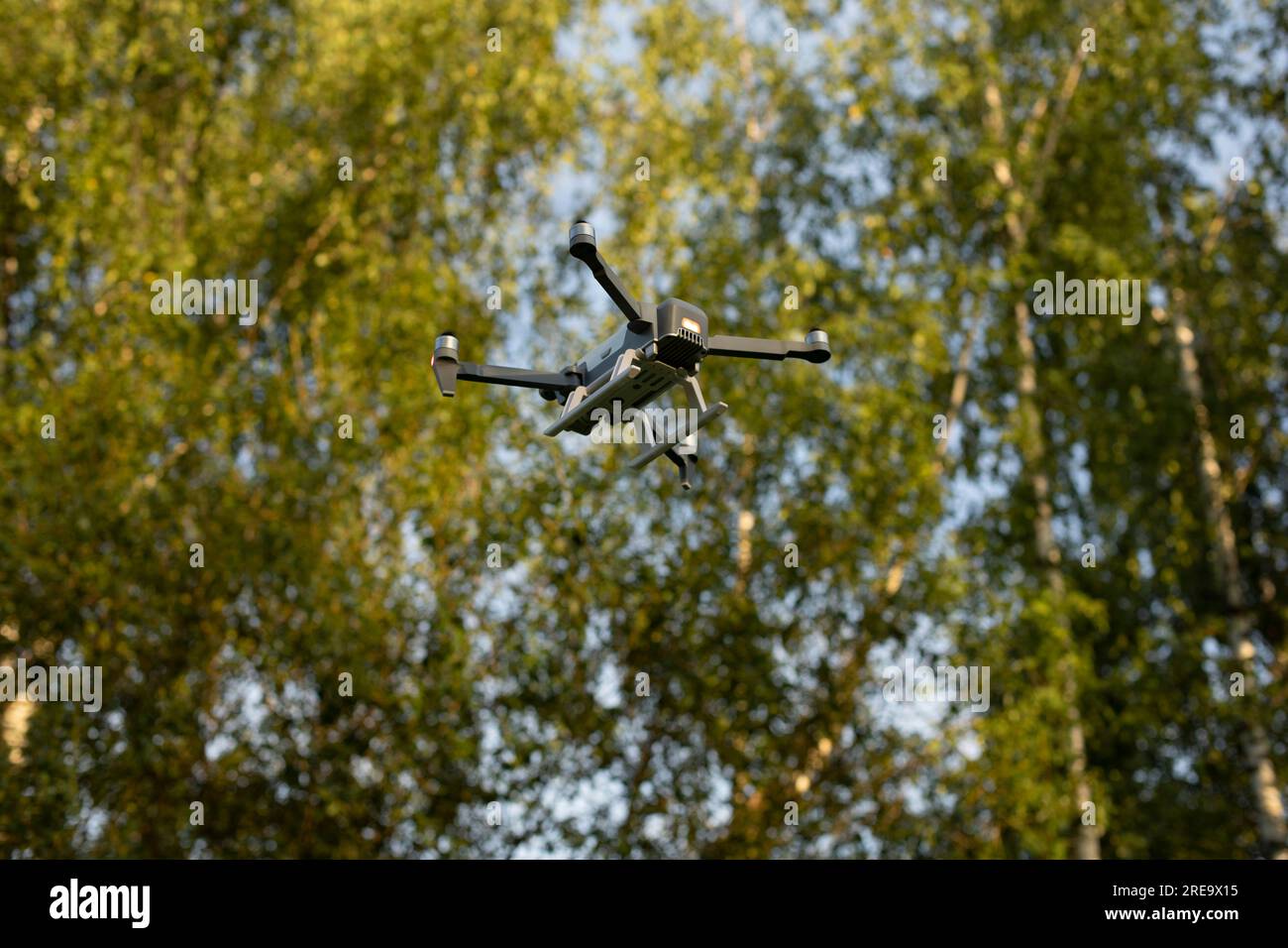 Drone in flight. Quadro copter in sky. Take-off of electric transport ...