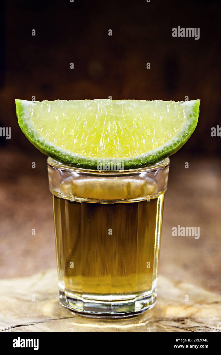 glass of alcoholic drink with lemon, distilled from sugar cane, called ...