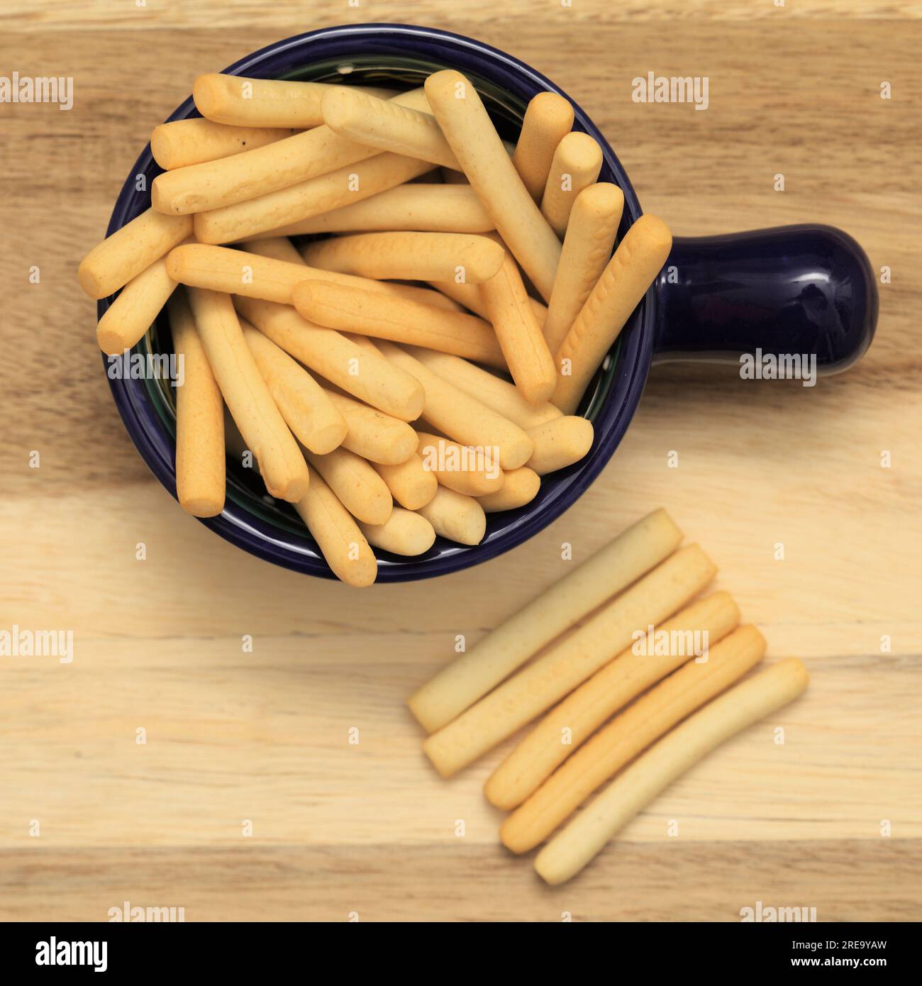 Handfull of short thin white bread breadsticks aka grissini Stock Photo ...