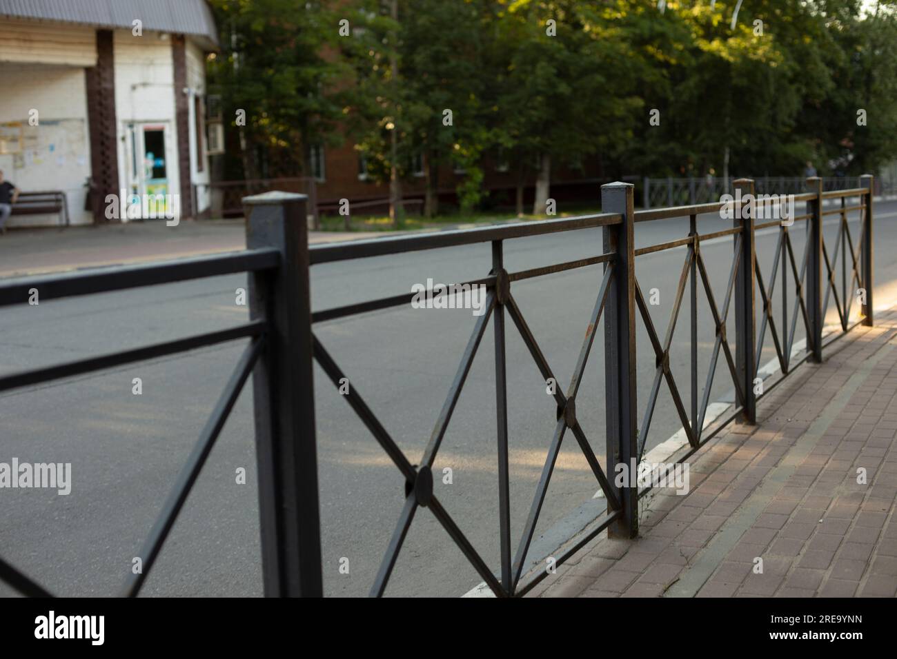 Fence by road. Fence in city. Protection against cars. Empty road Stock ...
