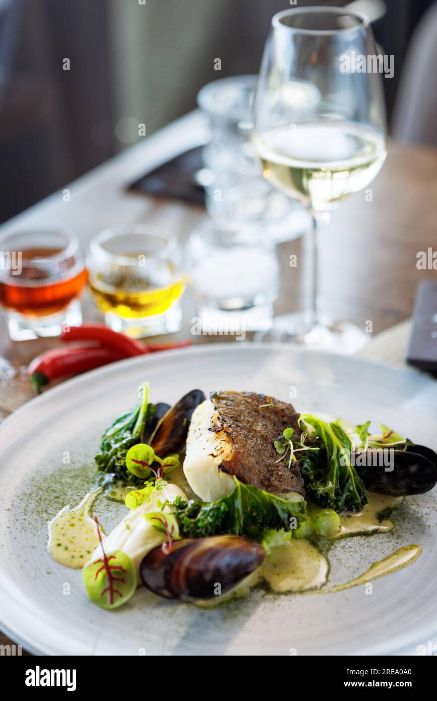 Cod fillet with cauliflower cream, asparagus, clam-wine sauce and ...