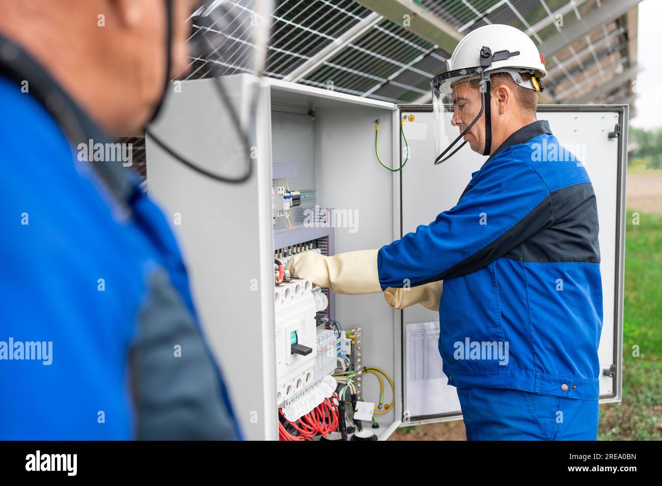 Two Service Engineers or electrician working on checking transformer site and solving problem ...