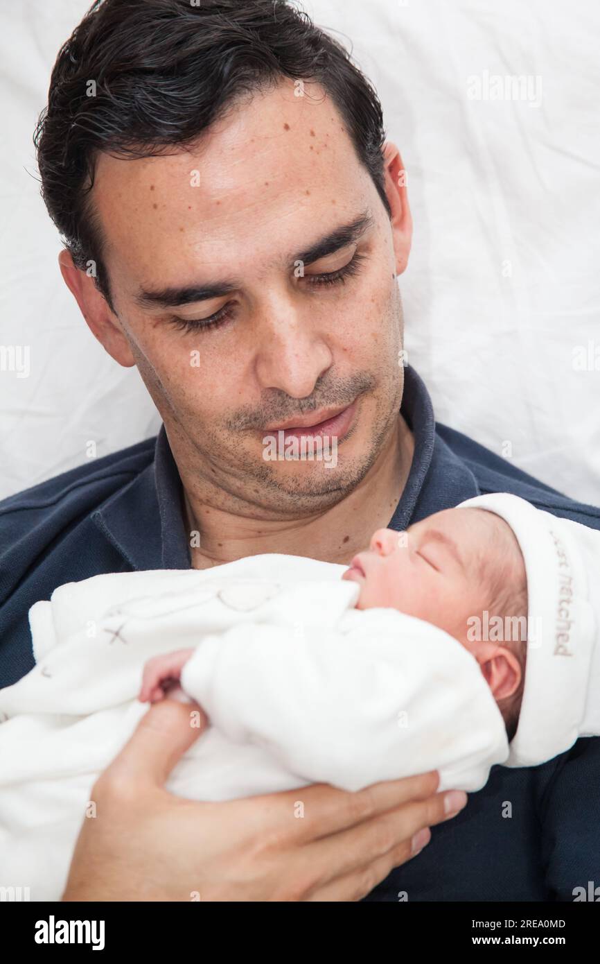Young father at the hospital with his newborn girl on the day of her ...