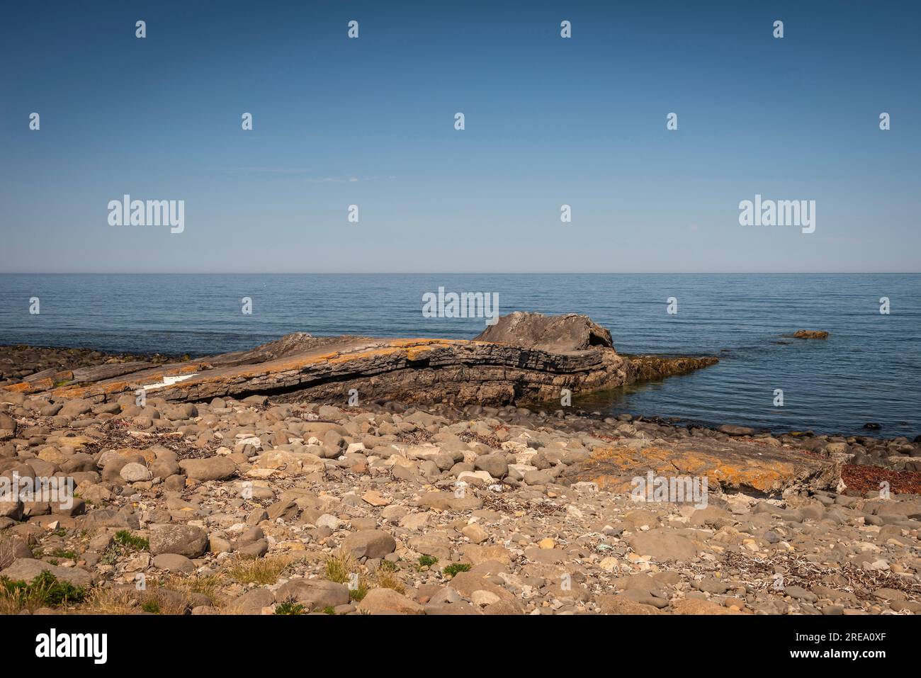 Natural stratigraphy or rock layers on the beach next to Dunstanburgh ...