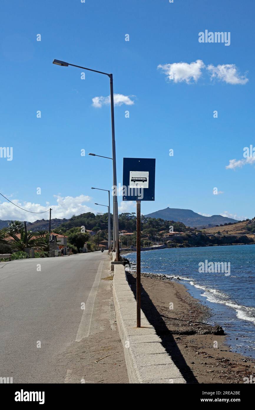 Greek sign for a bus stop alongside coast road from Petra village Stock ...
