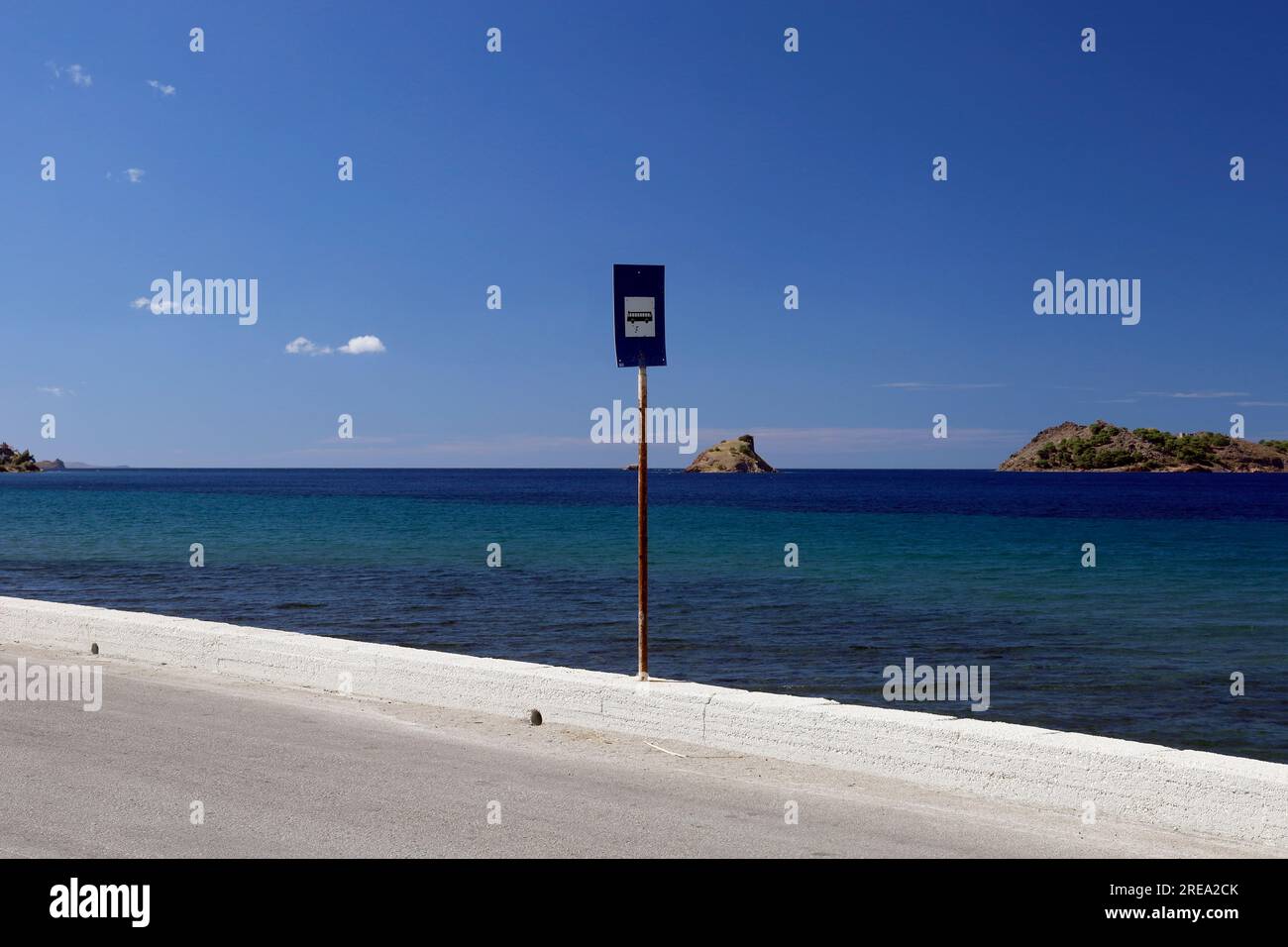 Greek sign for a bus stop alongside coast road from Petra village Stock ...