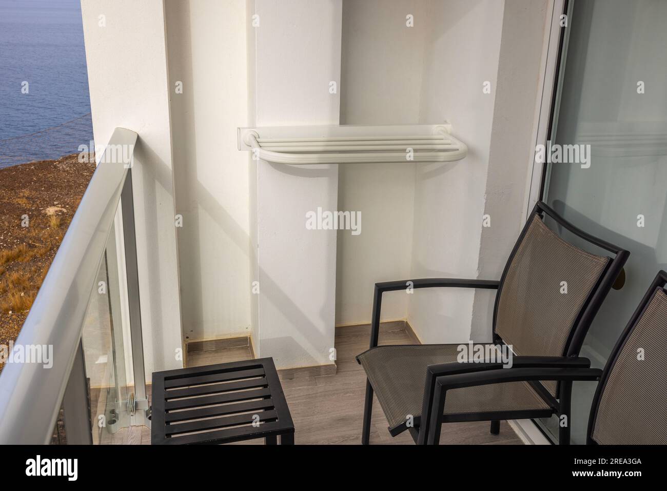 Atlantic ocean view balcony of hotel room with furniture outside. Gran ...