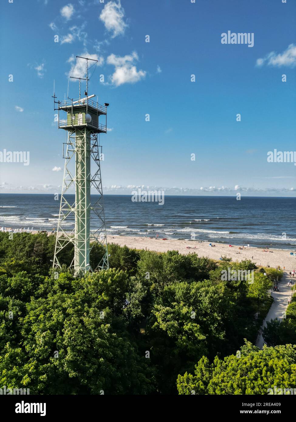 border observation tower with radar and antenna at sea shore with beach ...
