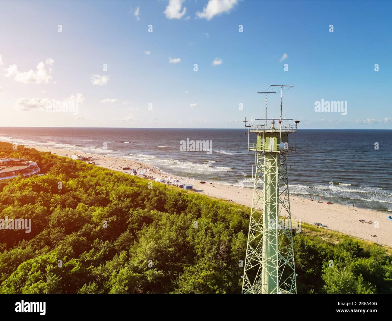 border observation tower with radar and antenna at sea shore with beach ...