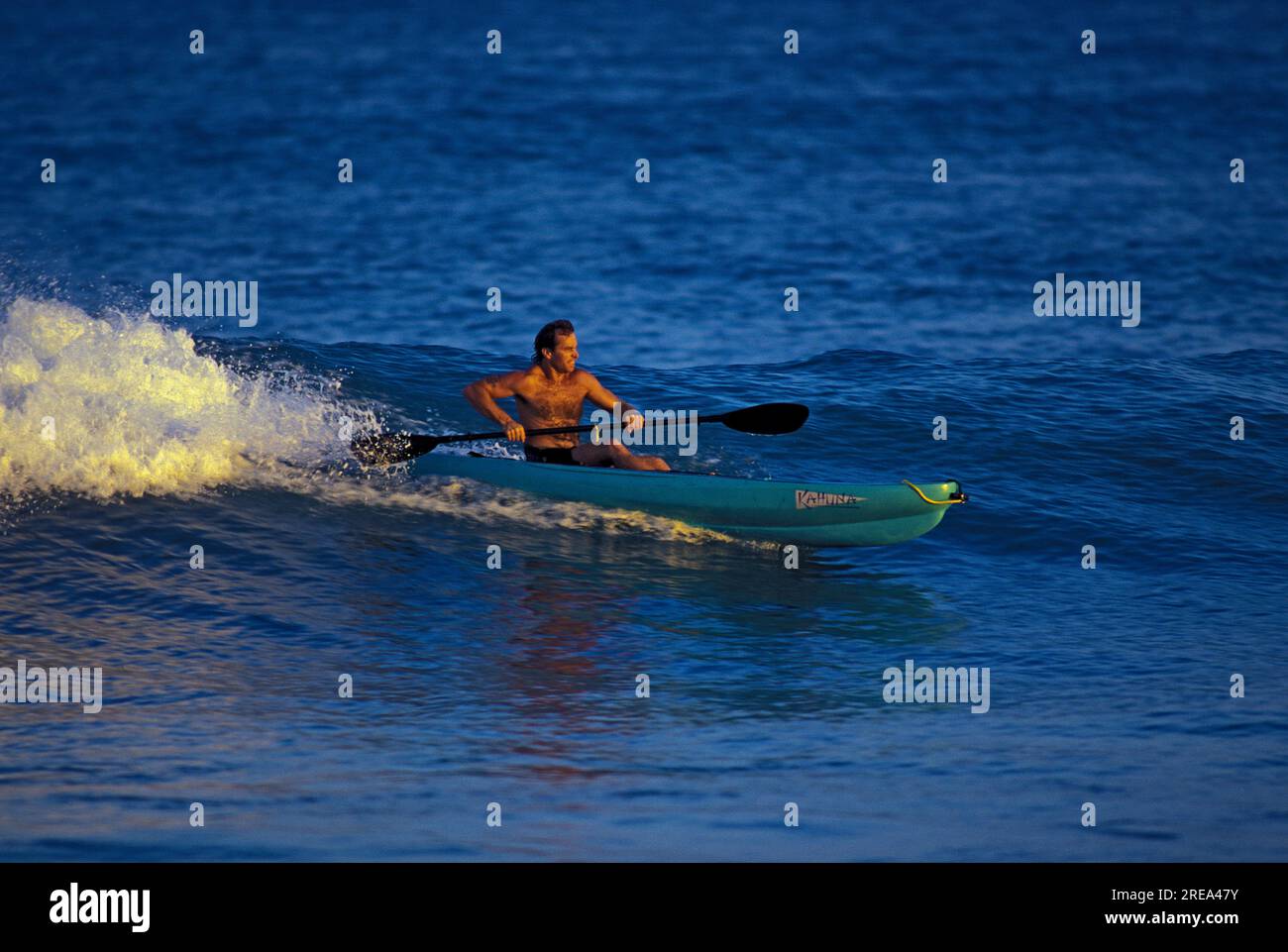 Man riding wave in a kayak Stock Photo - Alamy