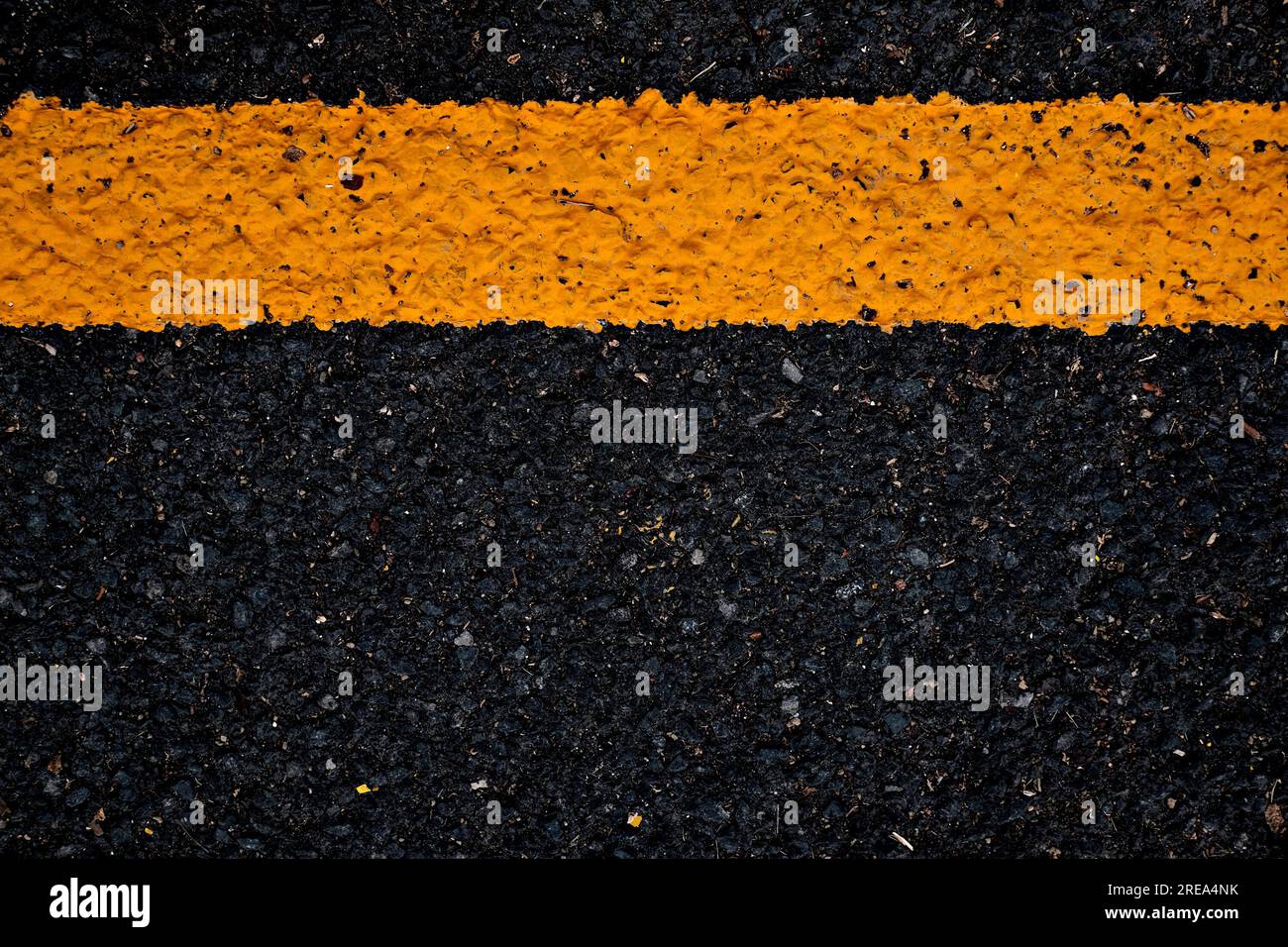 Wide bold yellow stripe over black background, paint on asphalt Stock ...