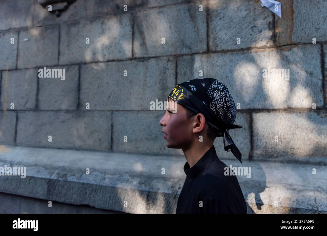 Srinagar, India. 26th July, 2023. A Shia Muslim boy looks on as Shia ...