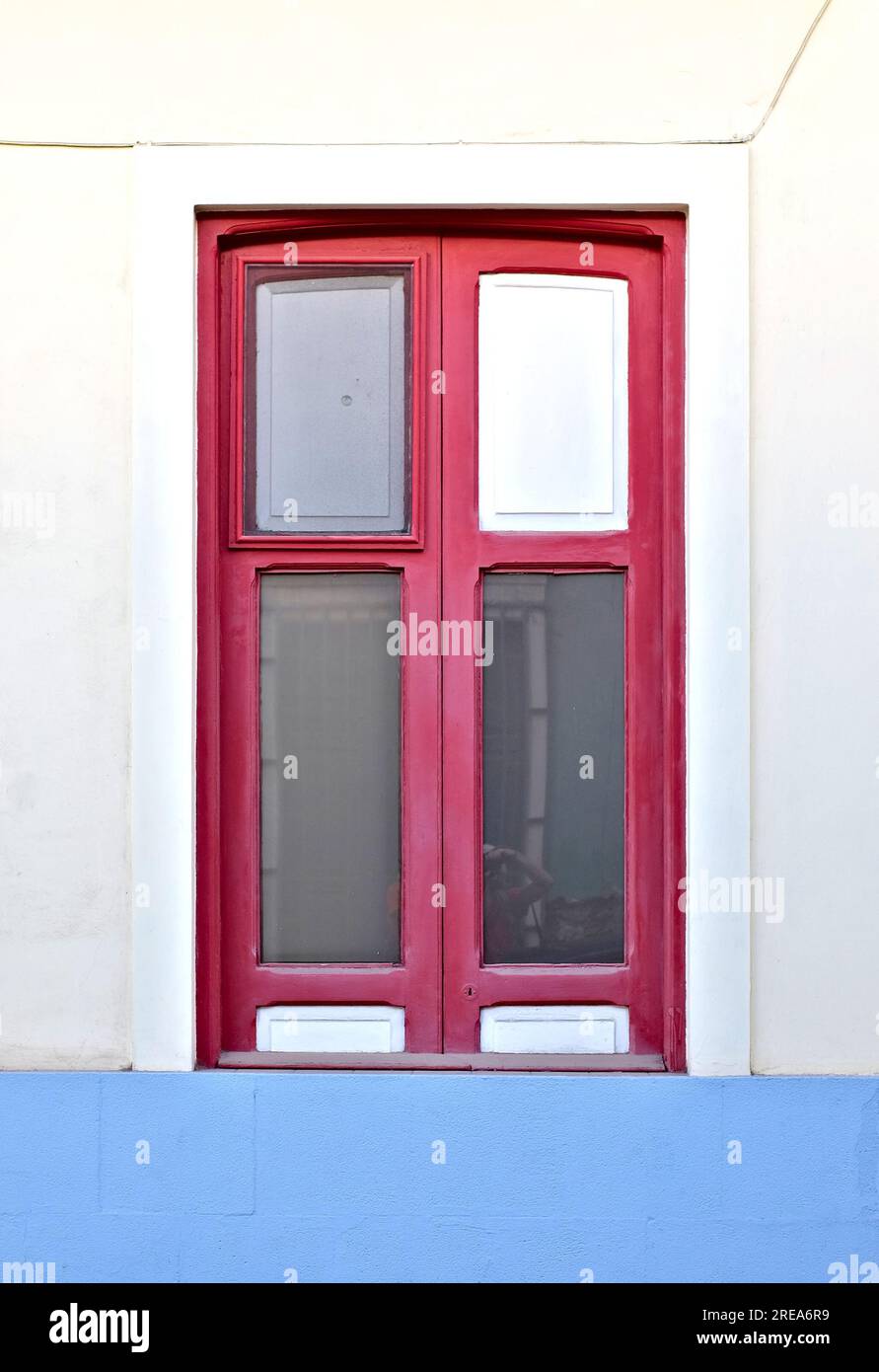 A simple red window in a pale blue wall Stock Photo - Alamy
