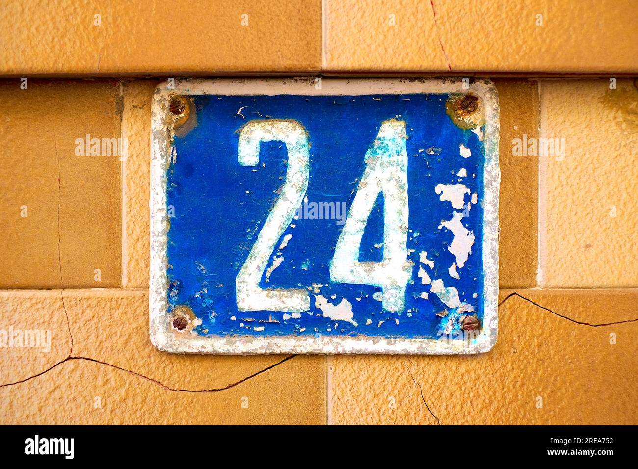 Number 24, twenty-four, grungy blue plate on tiles background Stock ...