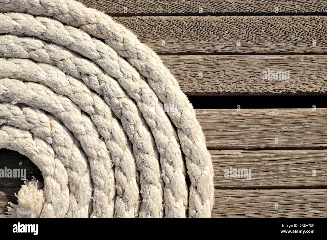 Concentric circles, coils of a line on a wooden background, close ...