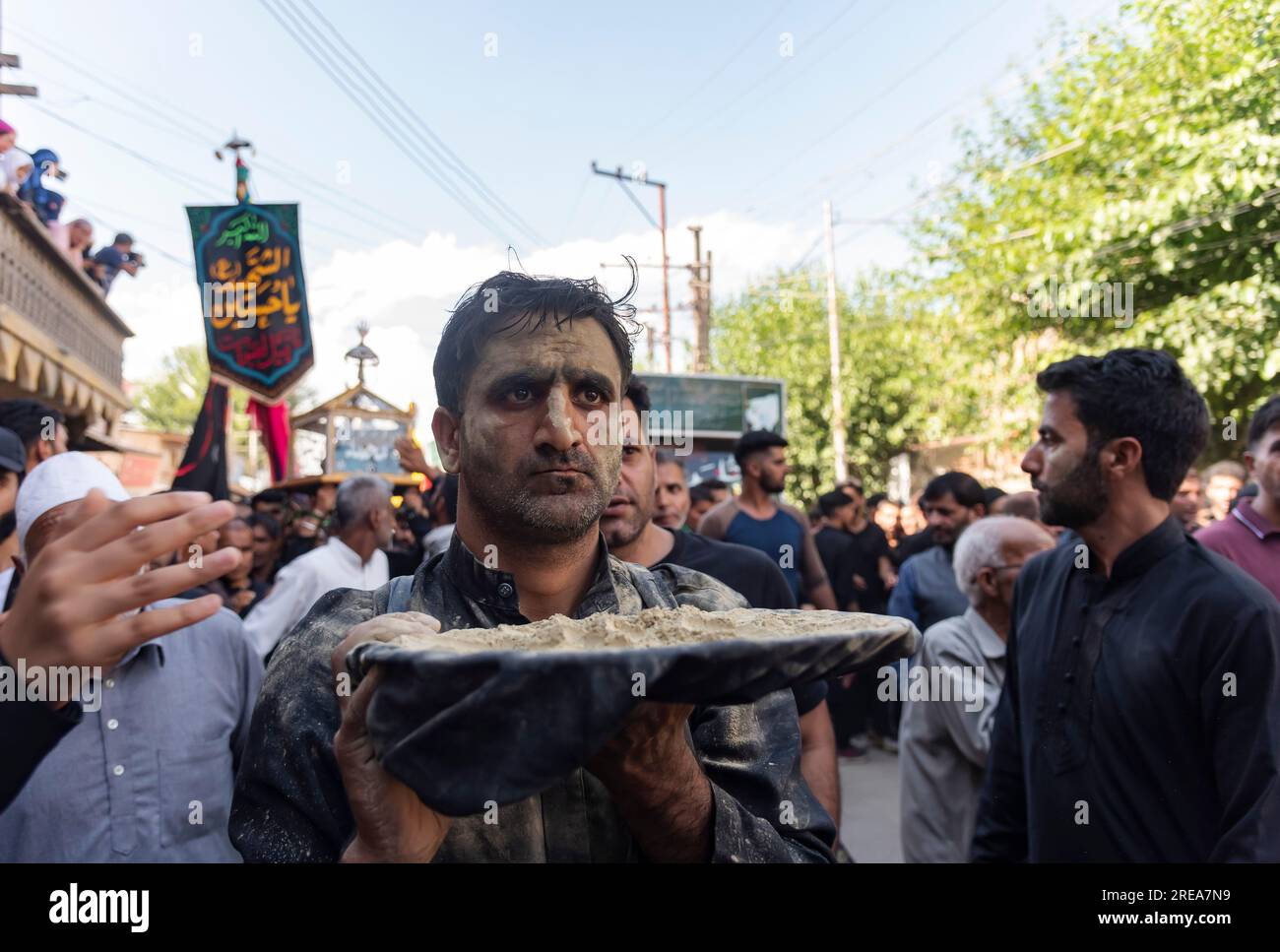 A Kashmiri Shia Muslim man smeared with mud taken from the soil of the ...