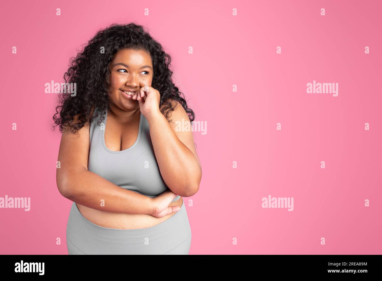 Young african american obese woman in sports outfit posing and looking ...