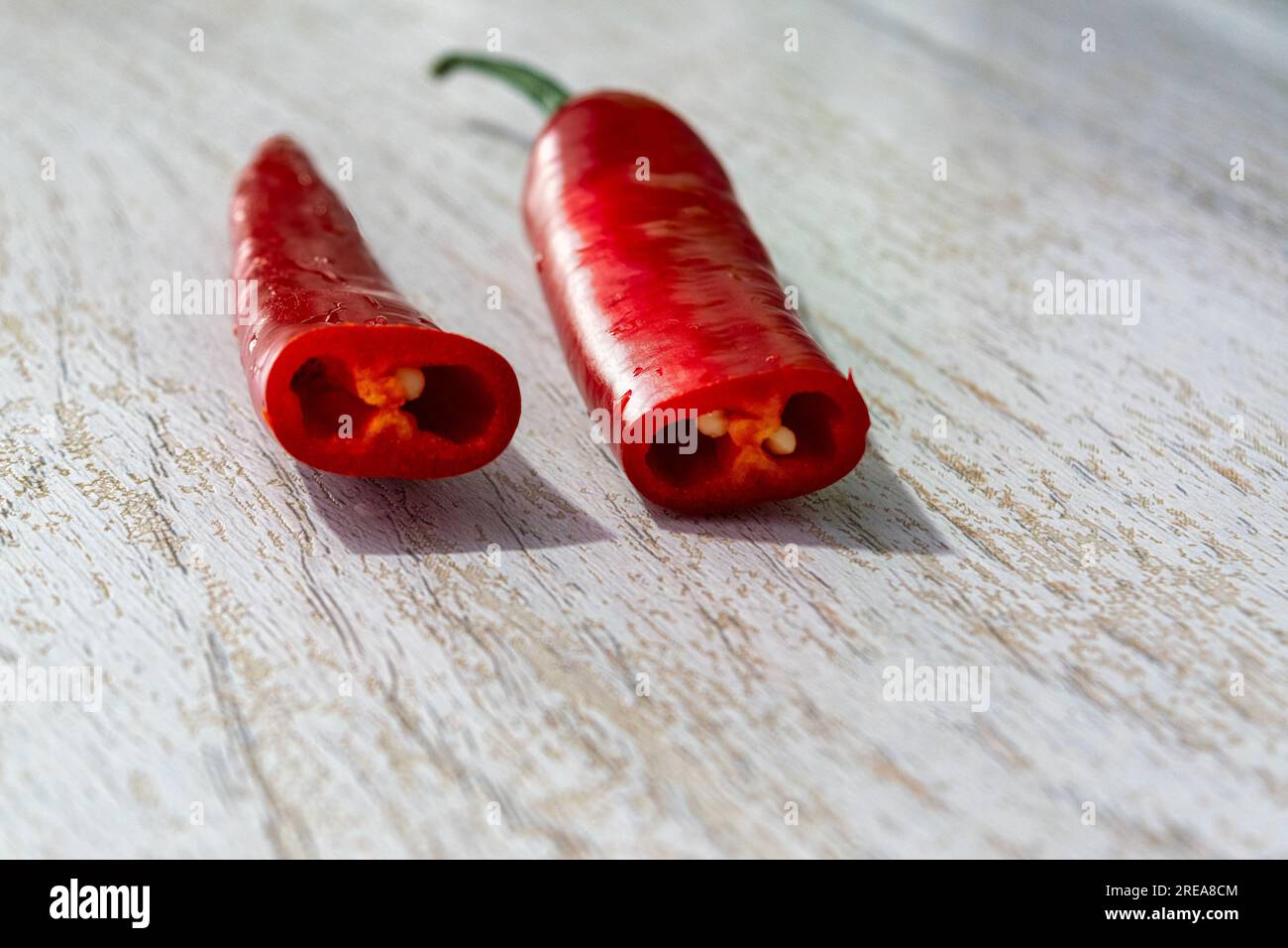 Red hot chili pepper. Cayenne pepper. Cut in half the fruit of a red ...