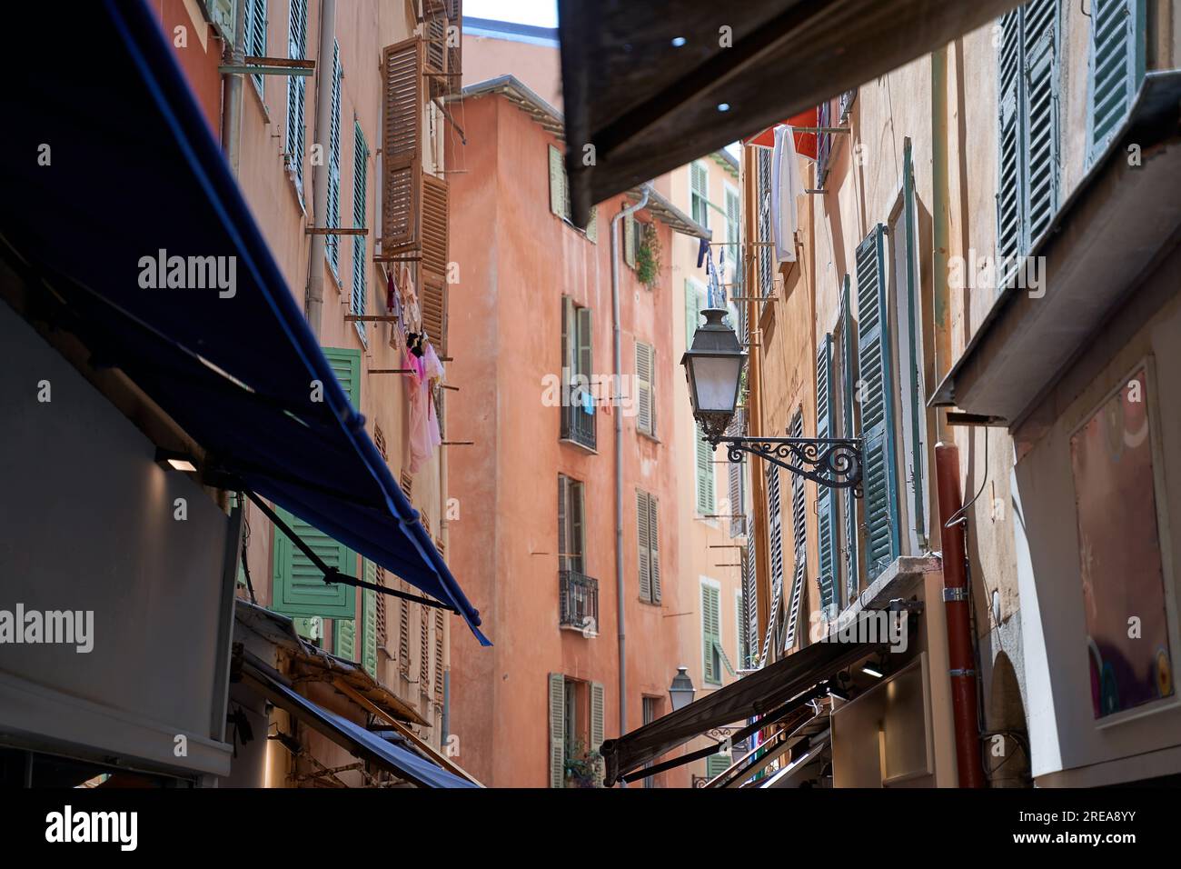 Narrow street with a lantern in the old town in Nice France Stock Photo ...