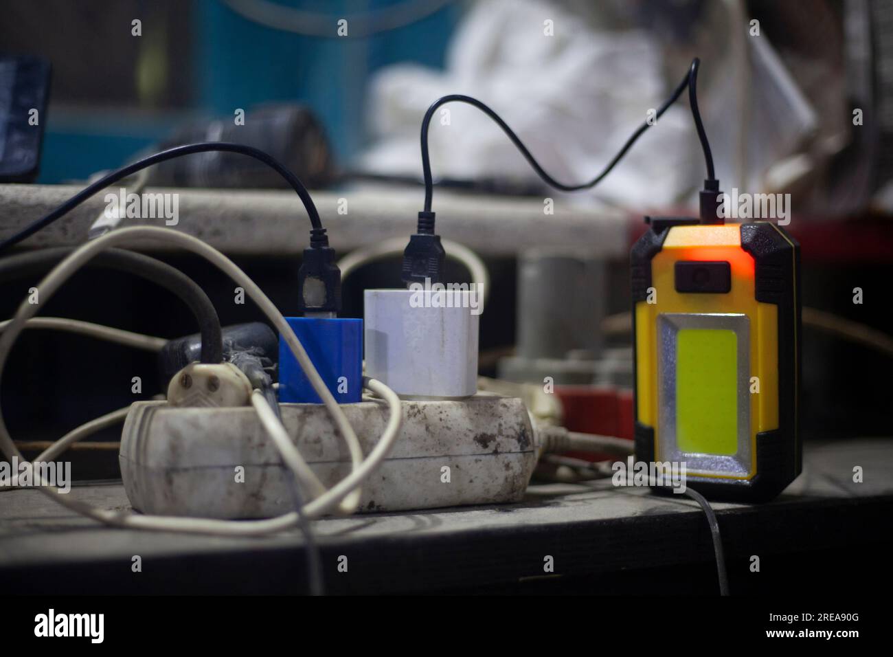 The charger is plugged in. Entangled wires from sockets of various ...