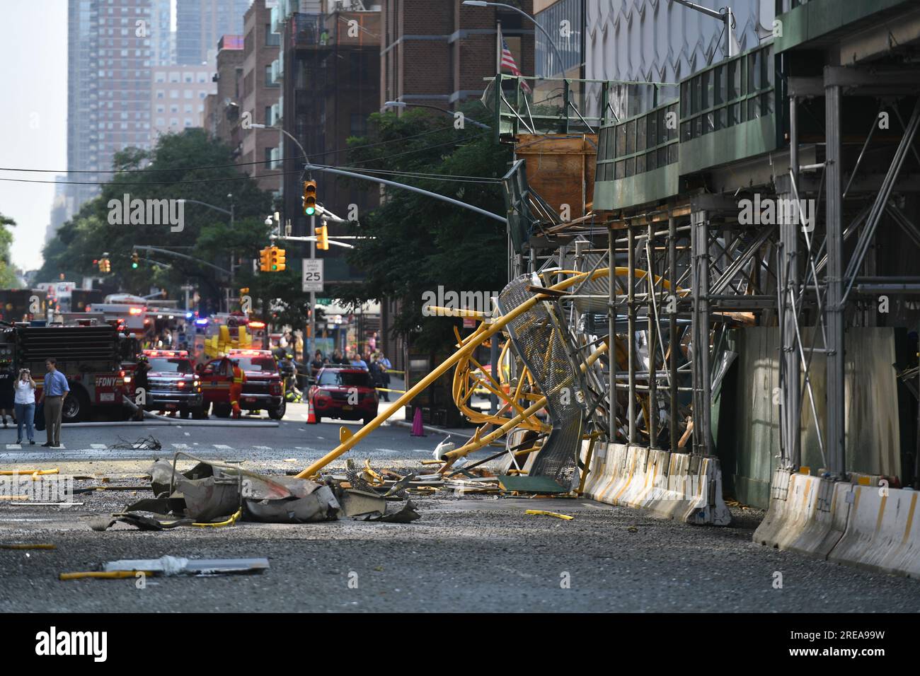 Debris from a crane collapse sit in the road as police, firefighters ...