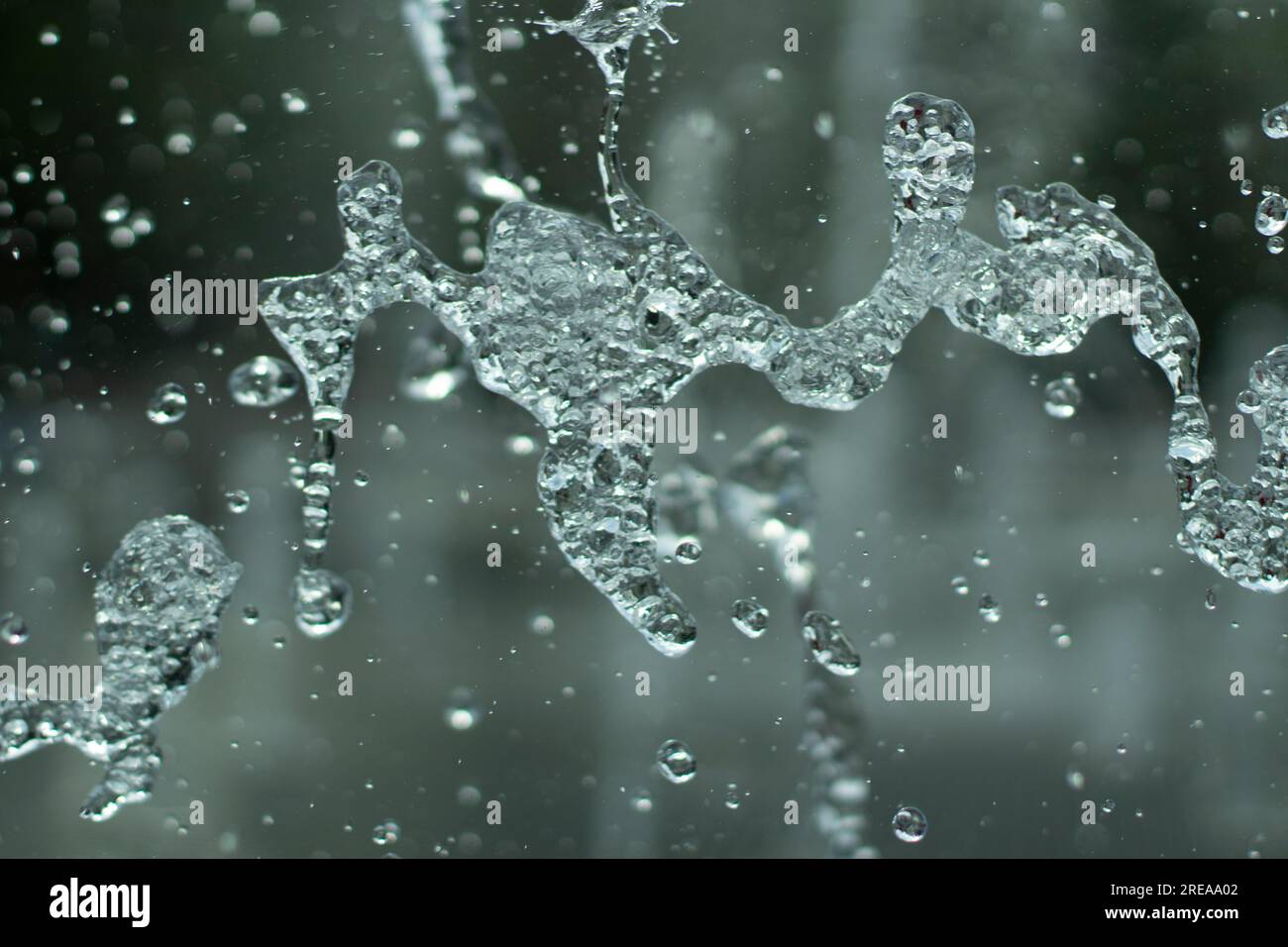 Water splashes large removed. Flight jet water. City fountain in detail ...