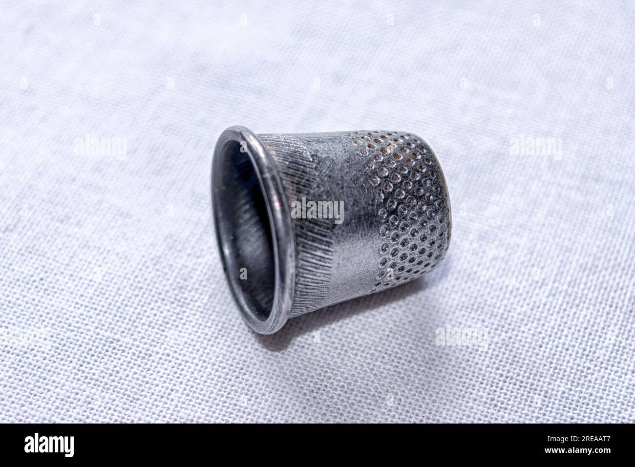 Metal thimble for sewing. Antique copper thimble on a white background ...