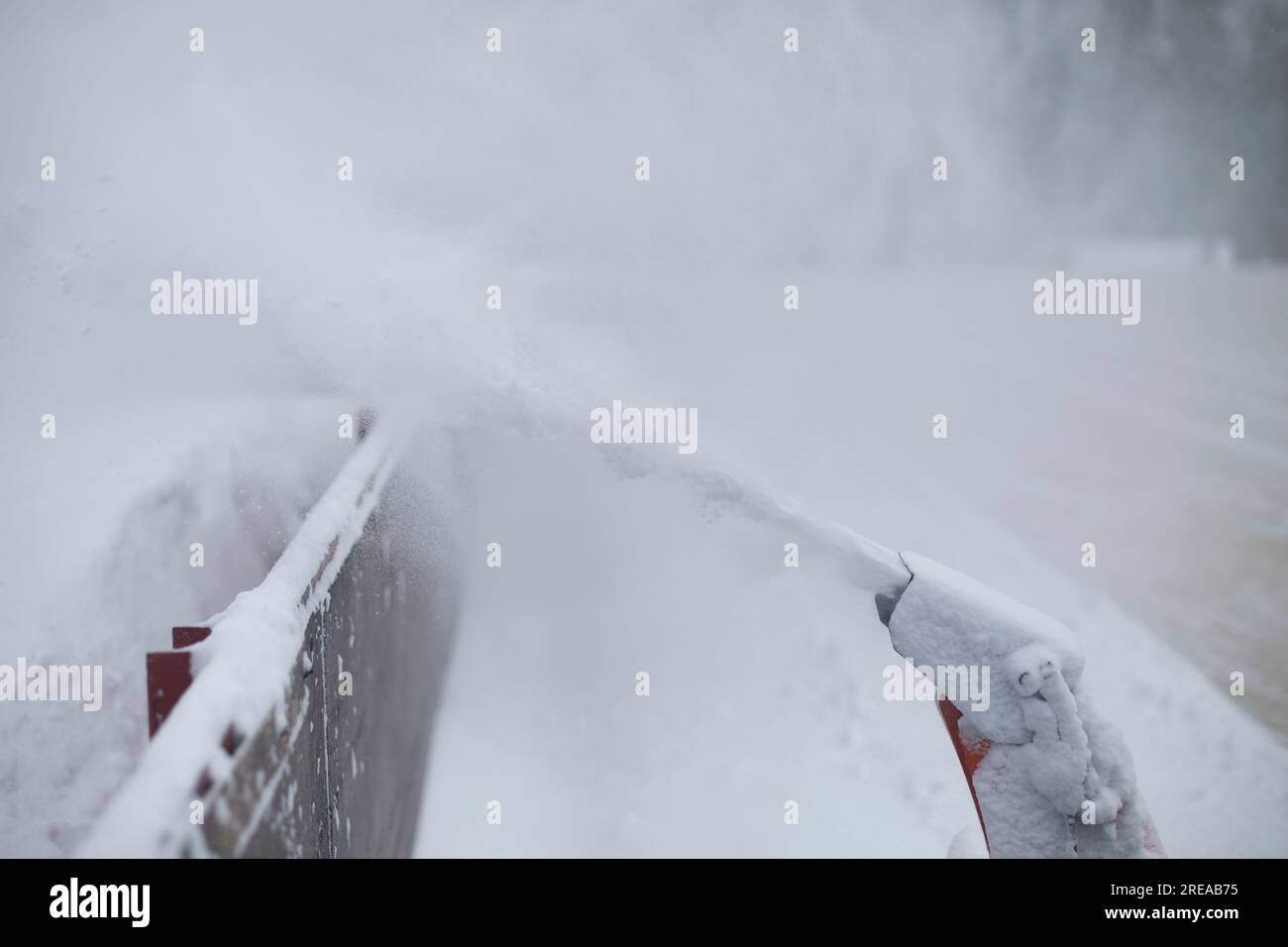 Snow ejection from ice rink. Snow removal equipment at hockey rink ...
