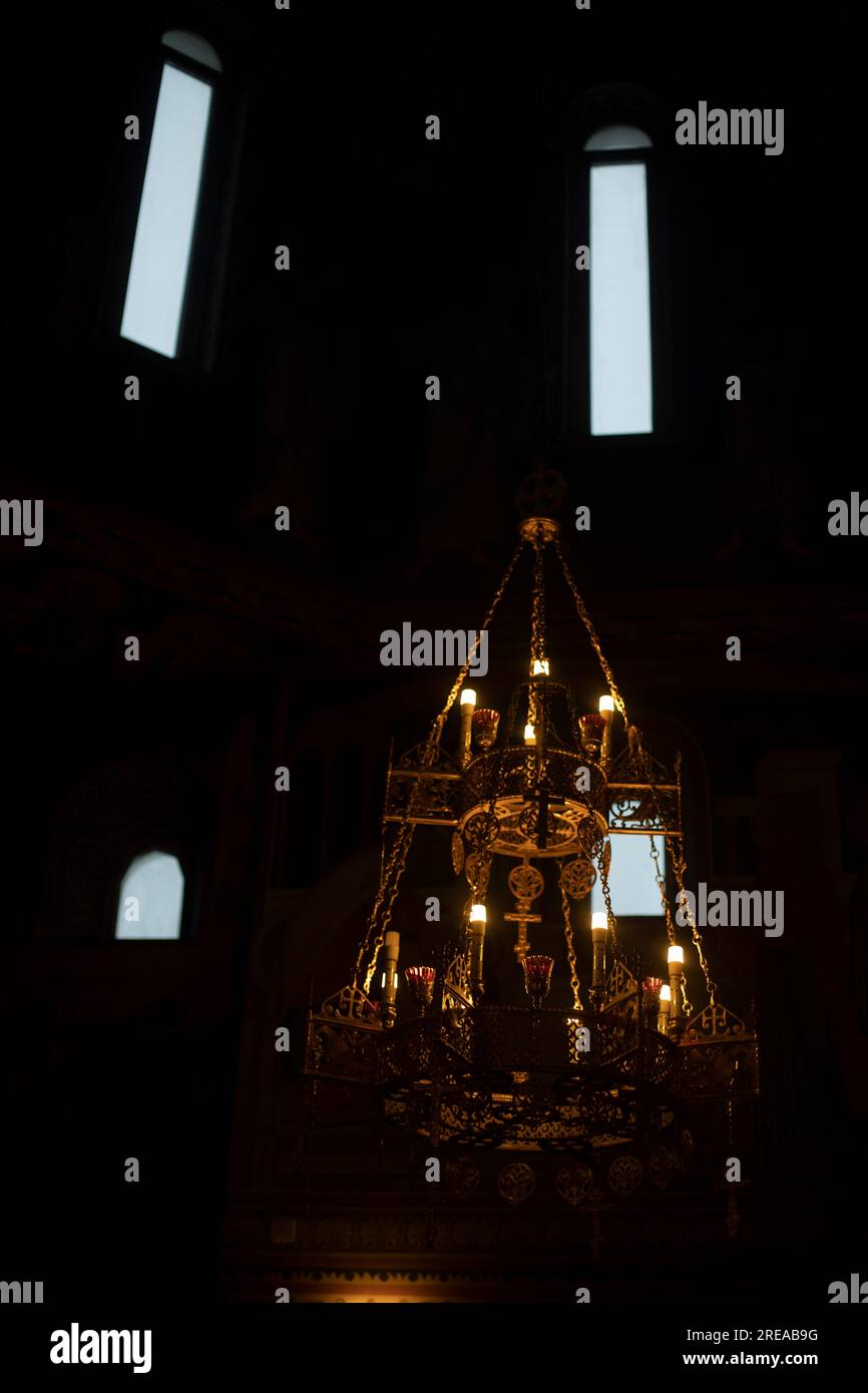 Interior of temple. Antique chandelier. Windows in dark. Lighting in ...