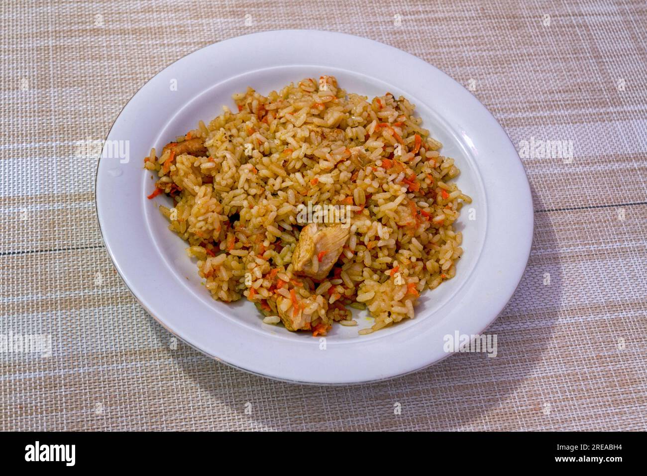 Portion of beef pilaf on a white background. Long grain rice ...