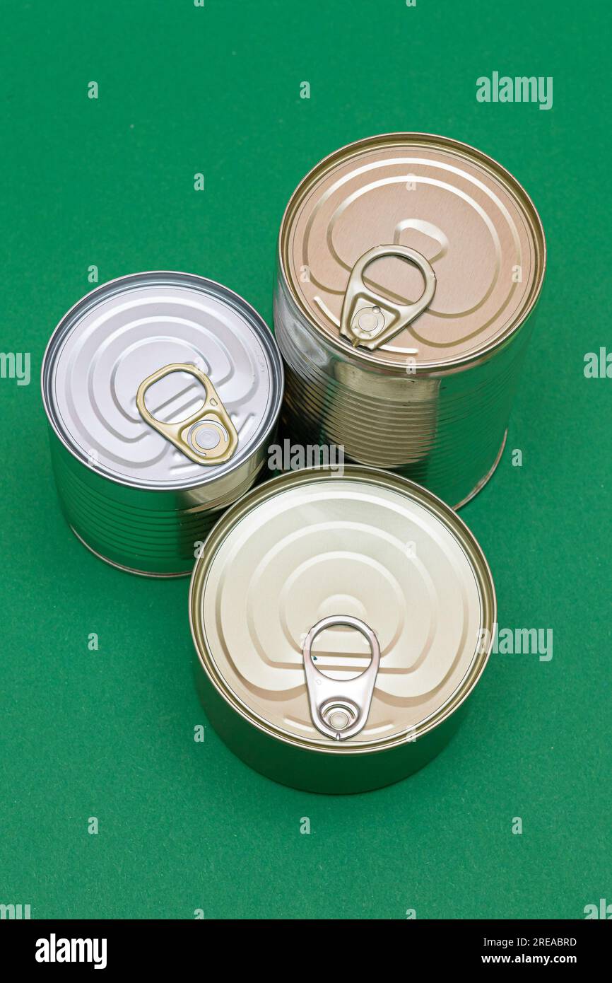 A Group of Stacked Tin Cans with Blank Edges on Green Background ...