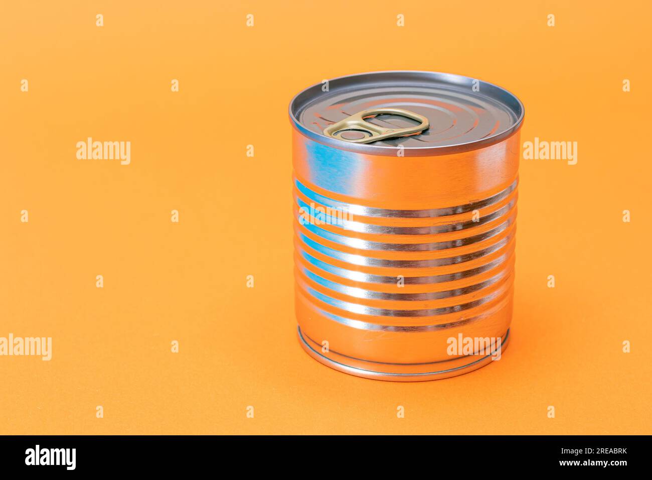 Unopened Tin Can with Blank Edge on Orange Background. Canned Food ...