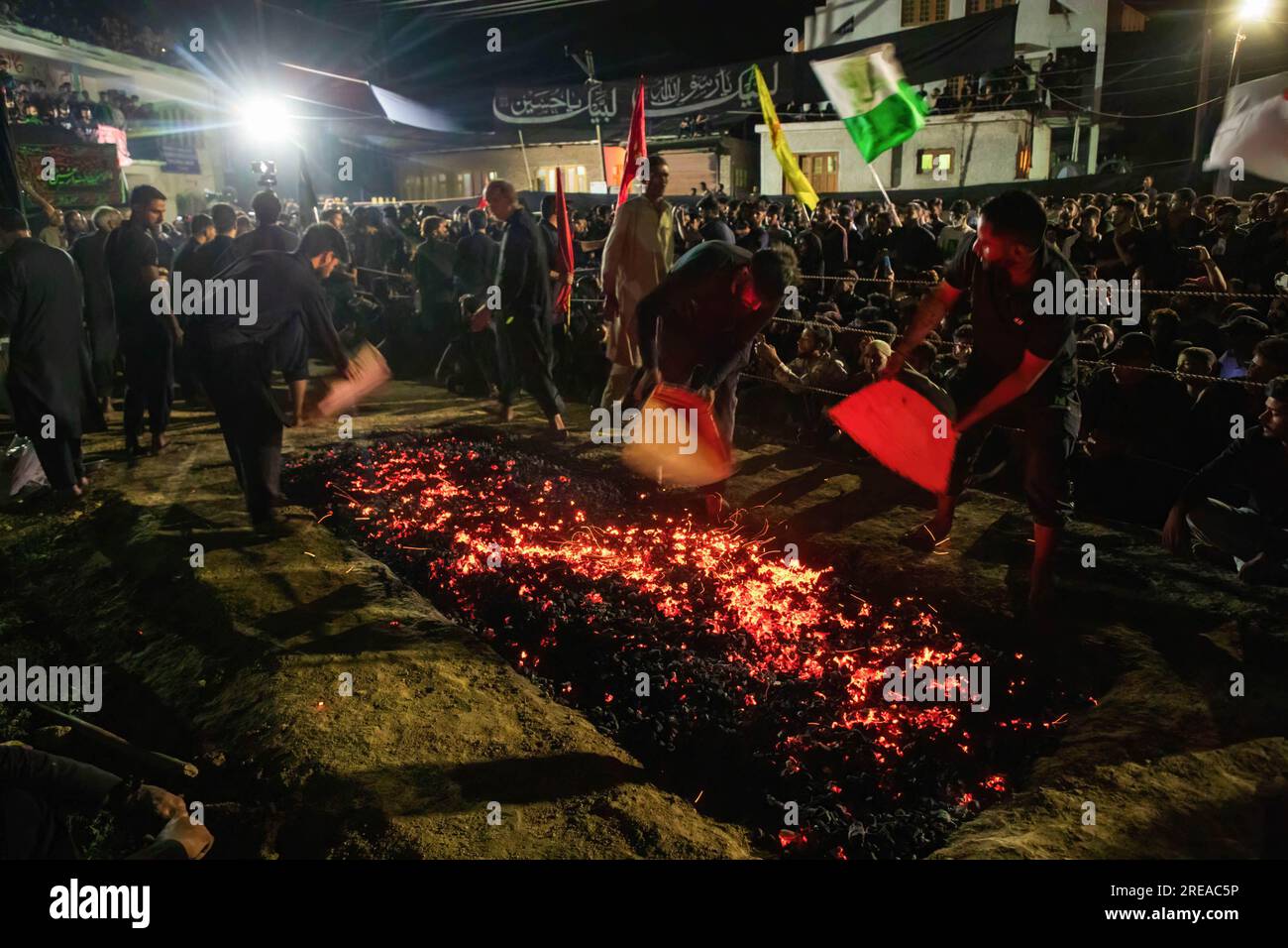 Kashmiri Shiite Muslim men prepare fire pit to take part in fire ...