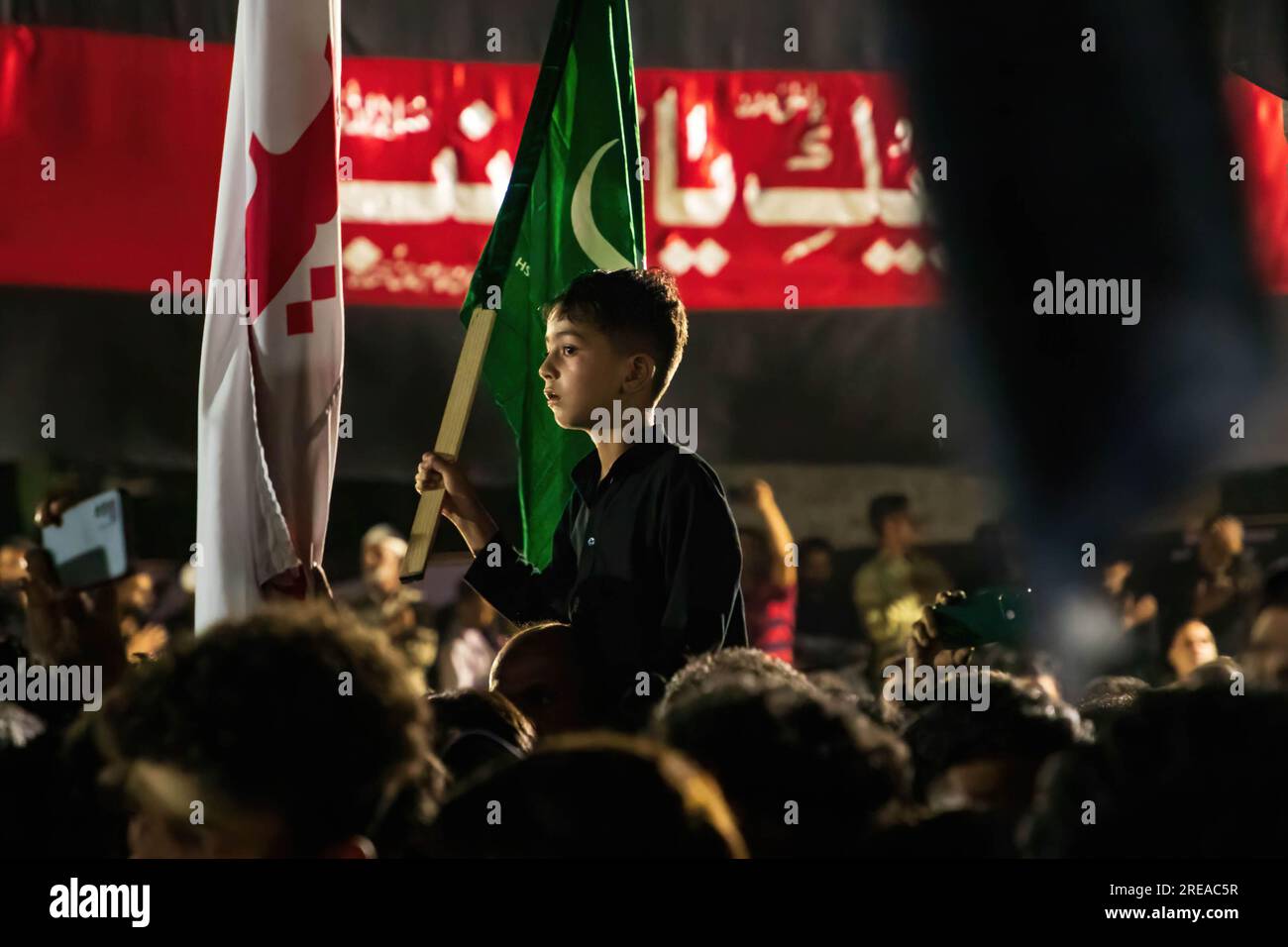 A Kashmiri Shiite Muslim boy looks on as mourners walk barefoot across ...